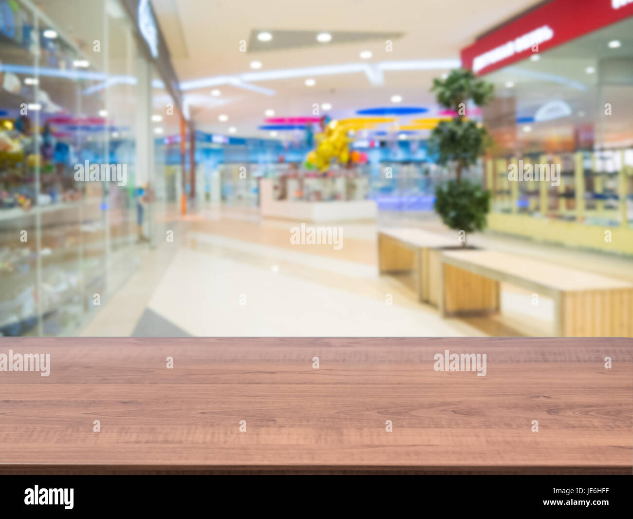 Brown wooden board empty table in front of blurred shopping mall - can ...
