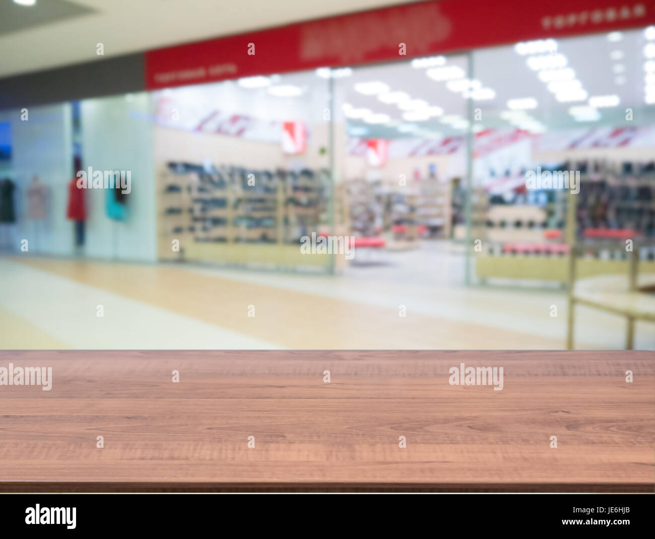 Brown wooden board empty table in front of blurred shopping mall - can ...