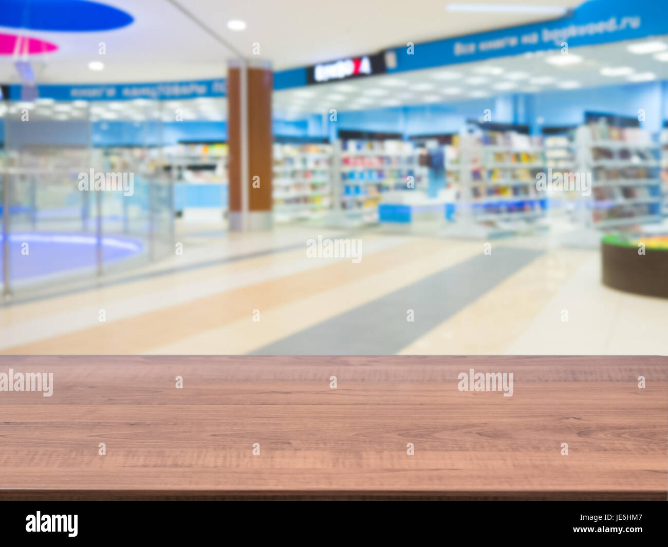 Brown wooden board empty table in front of blurred shopping mall - can ...