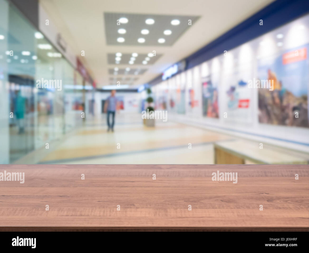 Brown wooden board empty table in front of blurred shopping mall - can ...