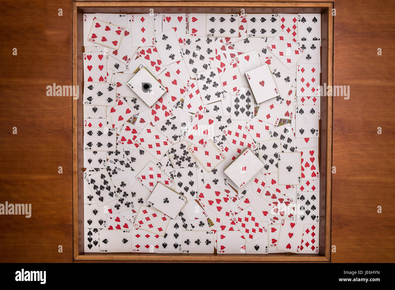 playing cards on square table Stock Photo - Alamy