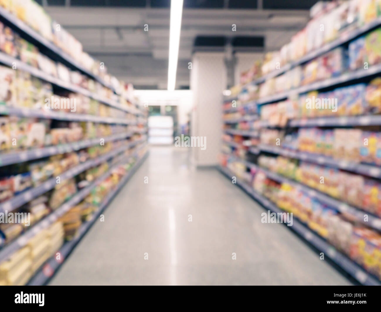 Abstract blurred supermarket aisle with colorful shelves and ...