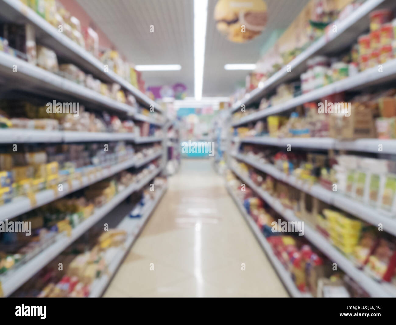 Abstract blurred supermarket aisle with colorful shelves and ...