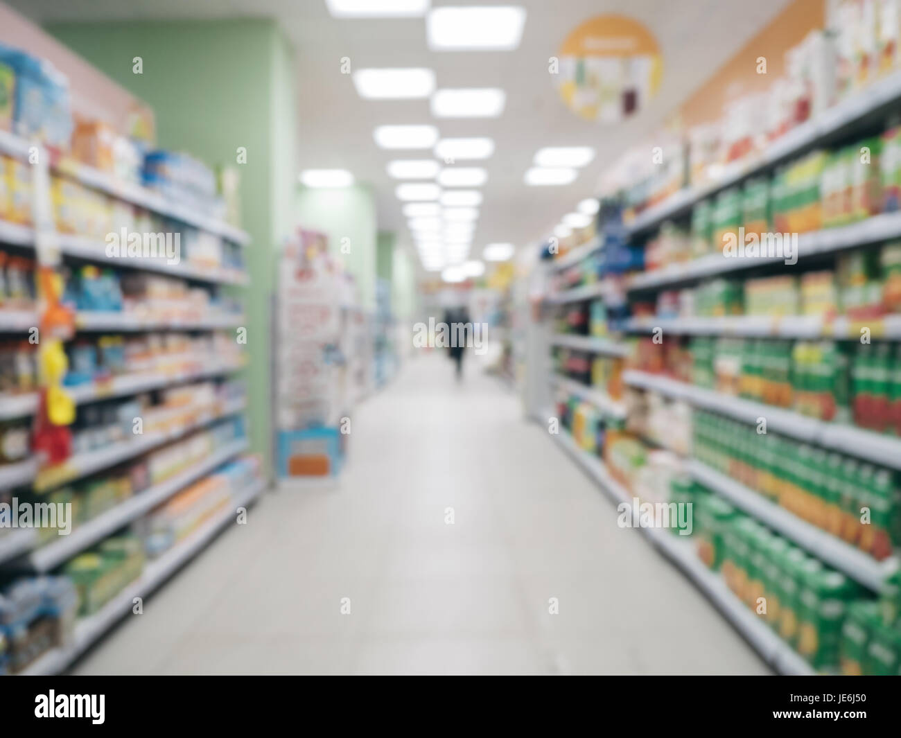 Abstract blurred supermarket with colorful shelves and unrecognizable ...