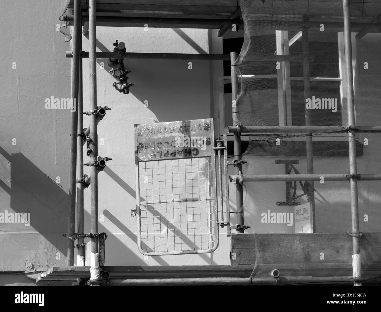 Scaffolding access gate to residential building undergoing renovation ...