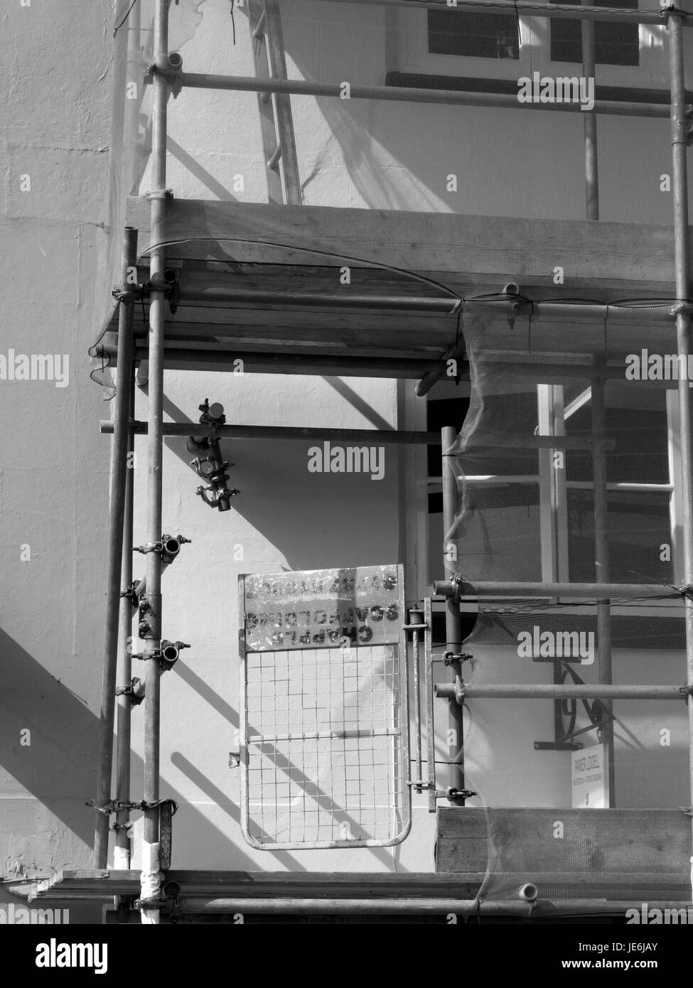 Scaffolding access gate to residential building undergoing renovation ...