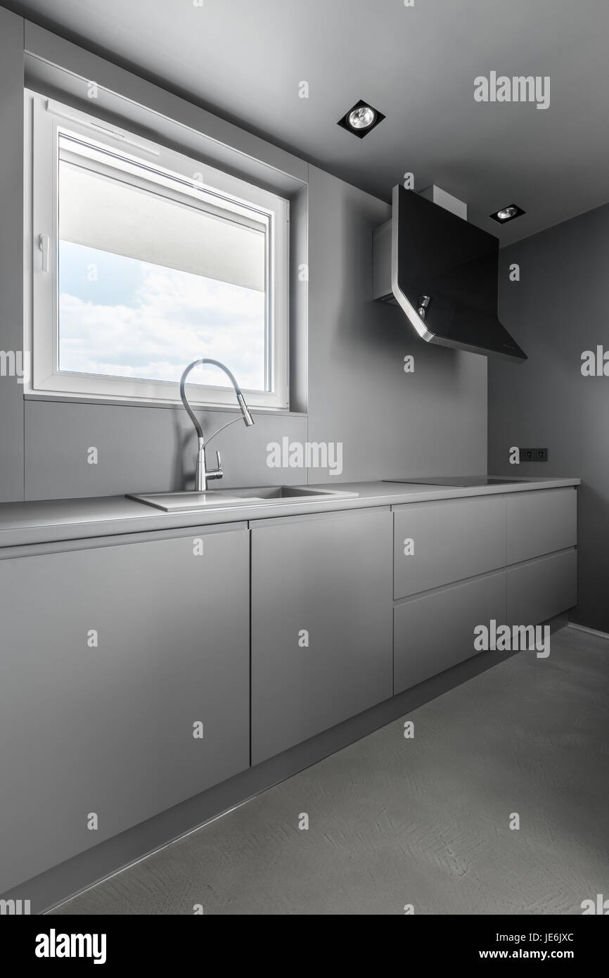 Gray kitchen with modern cupboards and window with blinds Stock Photo ...