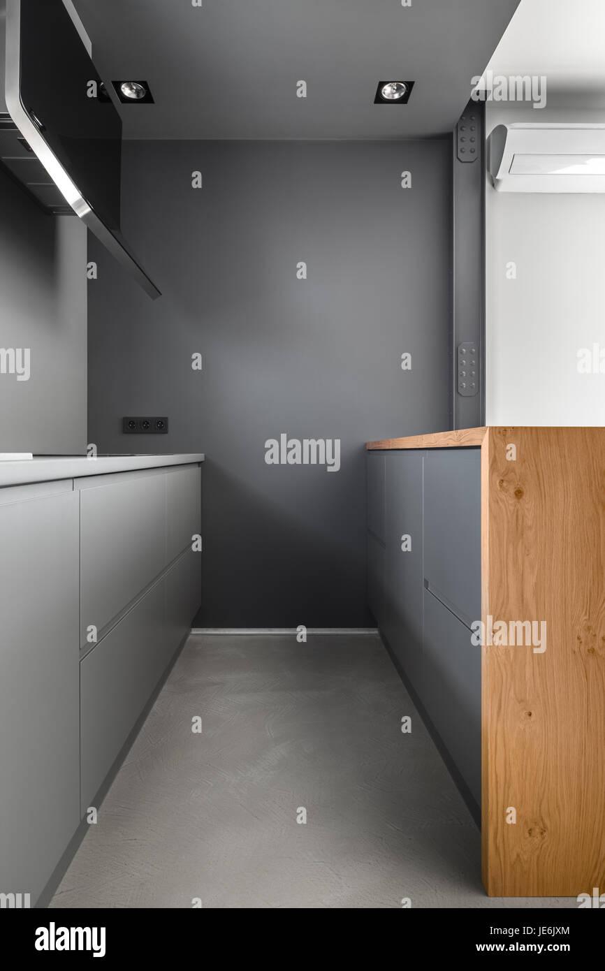 Small, gray kitchen with modern cupboards and island Stock Photo - Alamy