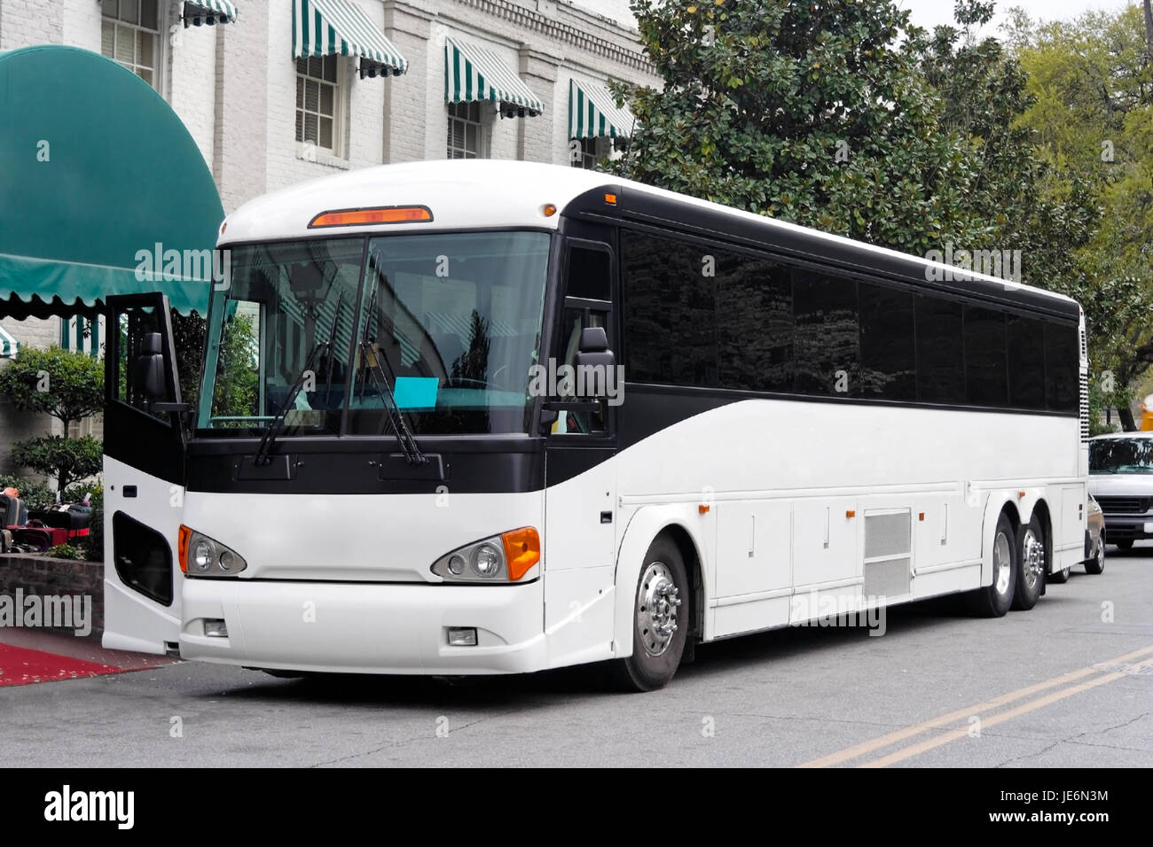 Tour bus parked at hotel awning. Horizontal Stock Photo - Alamy
