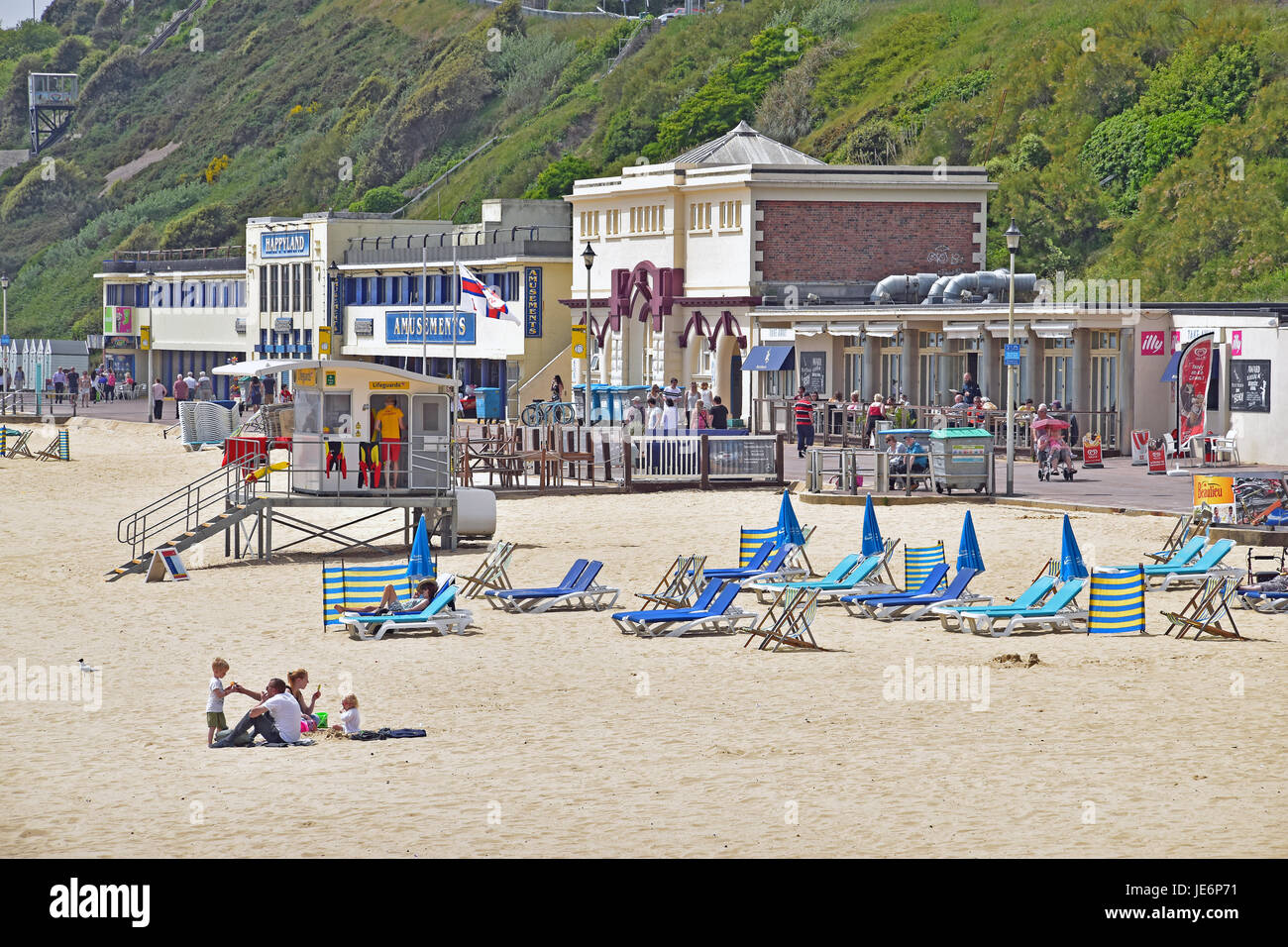 Family eating ice-cream next to lifeguard station on Bournemouth beach ...