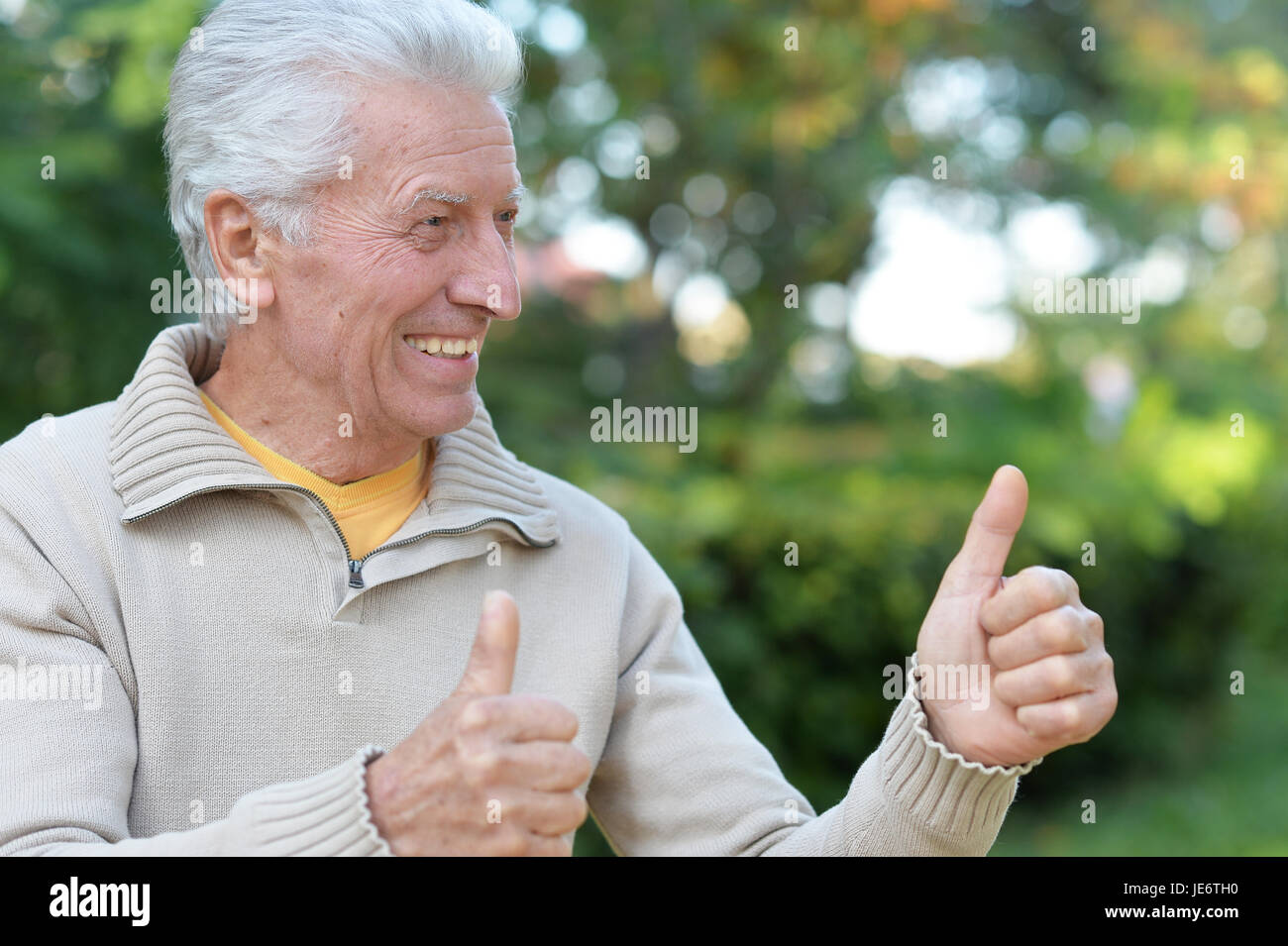 elderly man showing thumbs up Stock Photo - Alamy