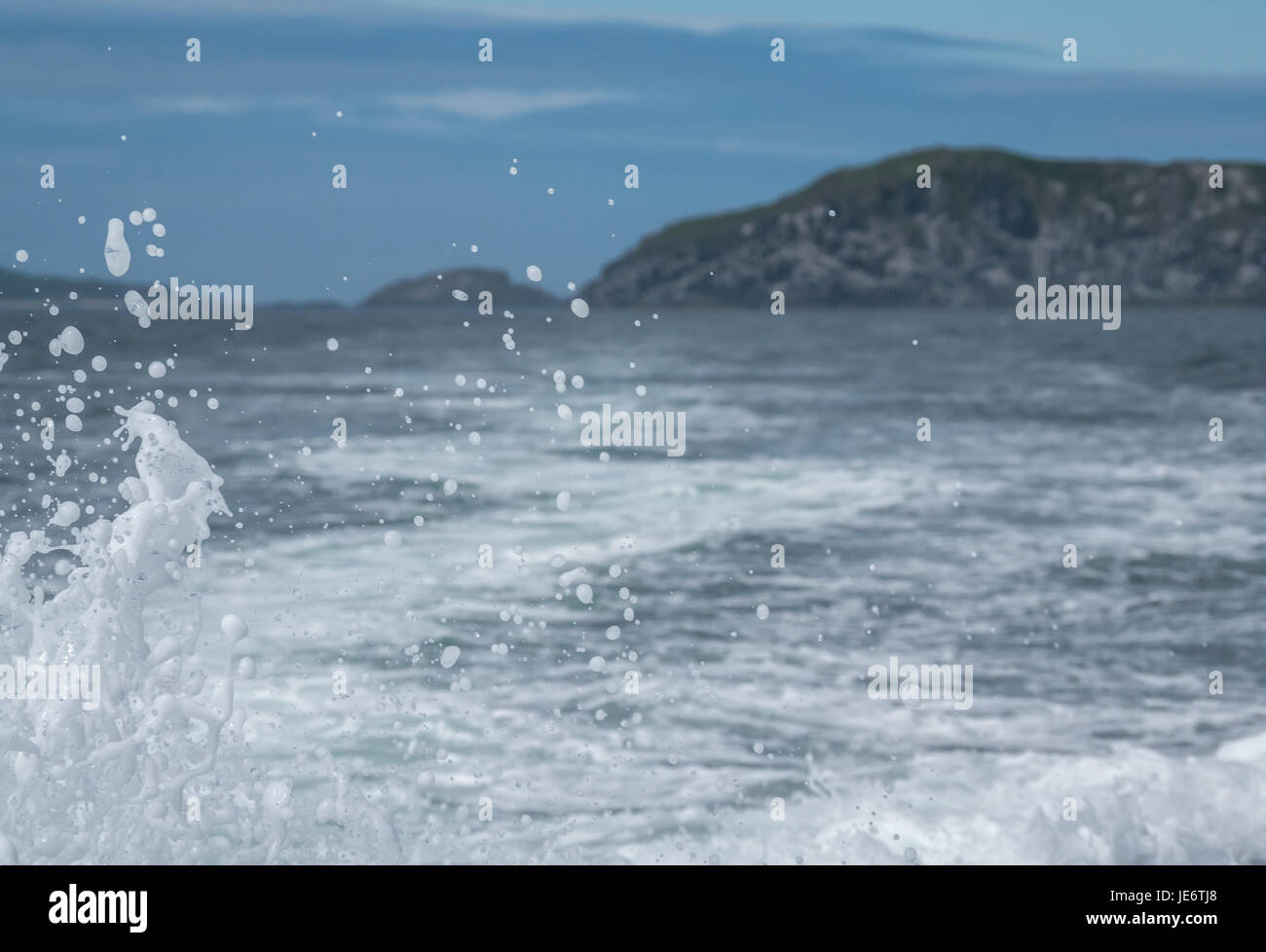Close up of water spray splash from churn of high speed outboard motor ...