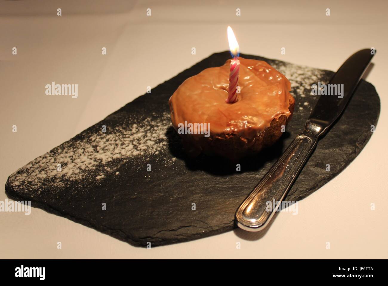 Birthday cake with one burning candle Stock Photo - Alamy