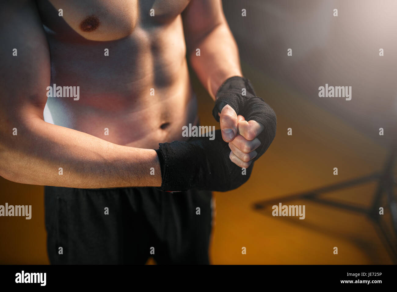 Muscular male person hands in black bandages. Boxing workout, mens ...