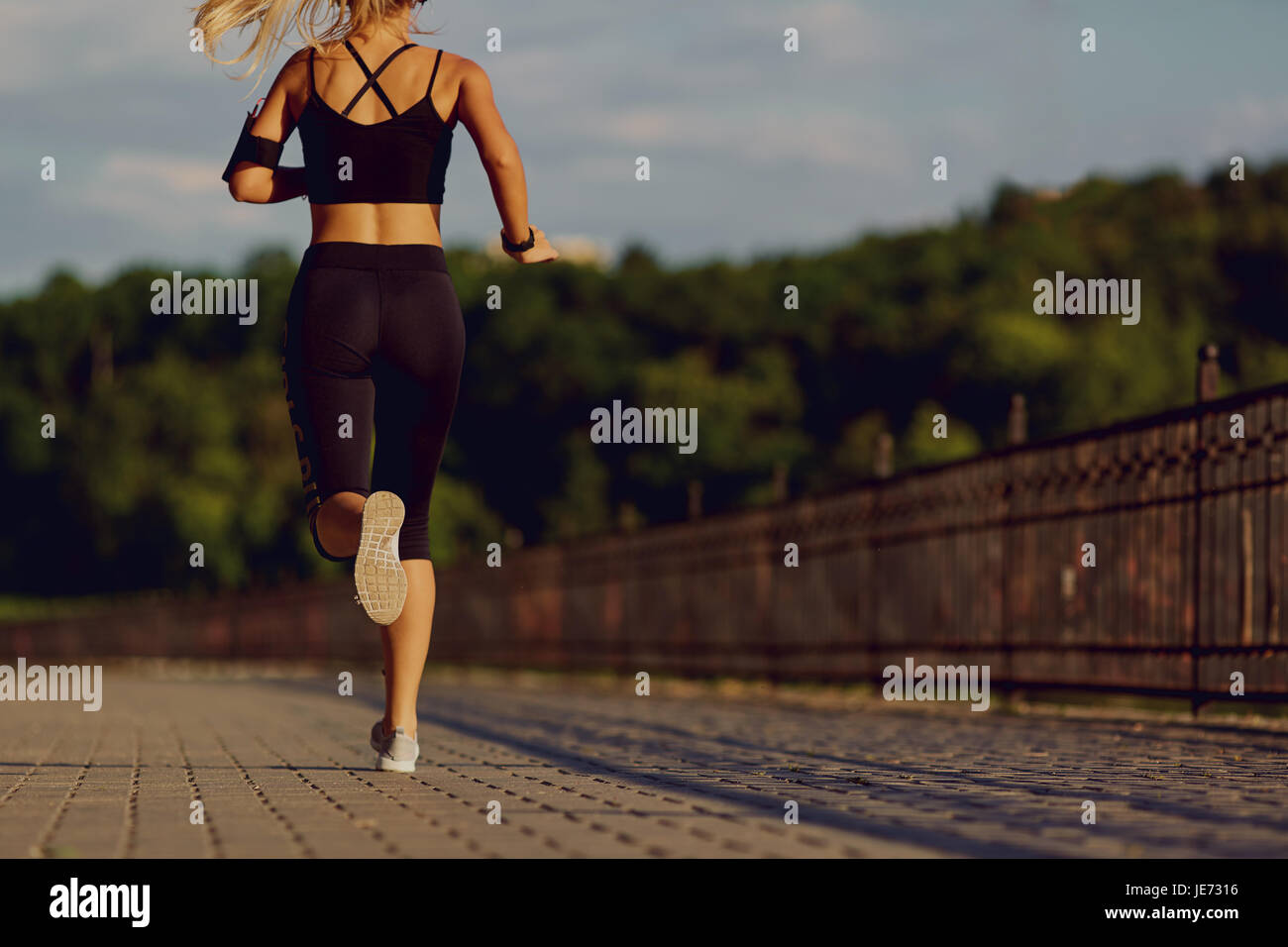 Girl runner jogging in the park in morning evening Stock Photo - Alamy