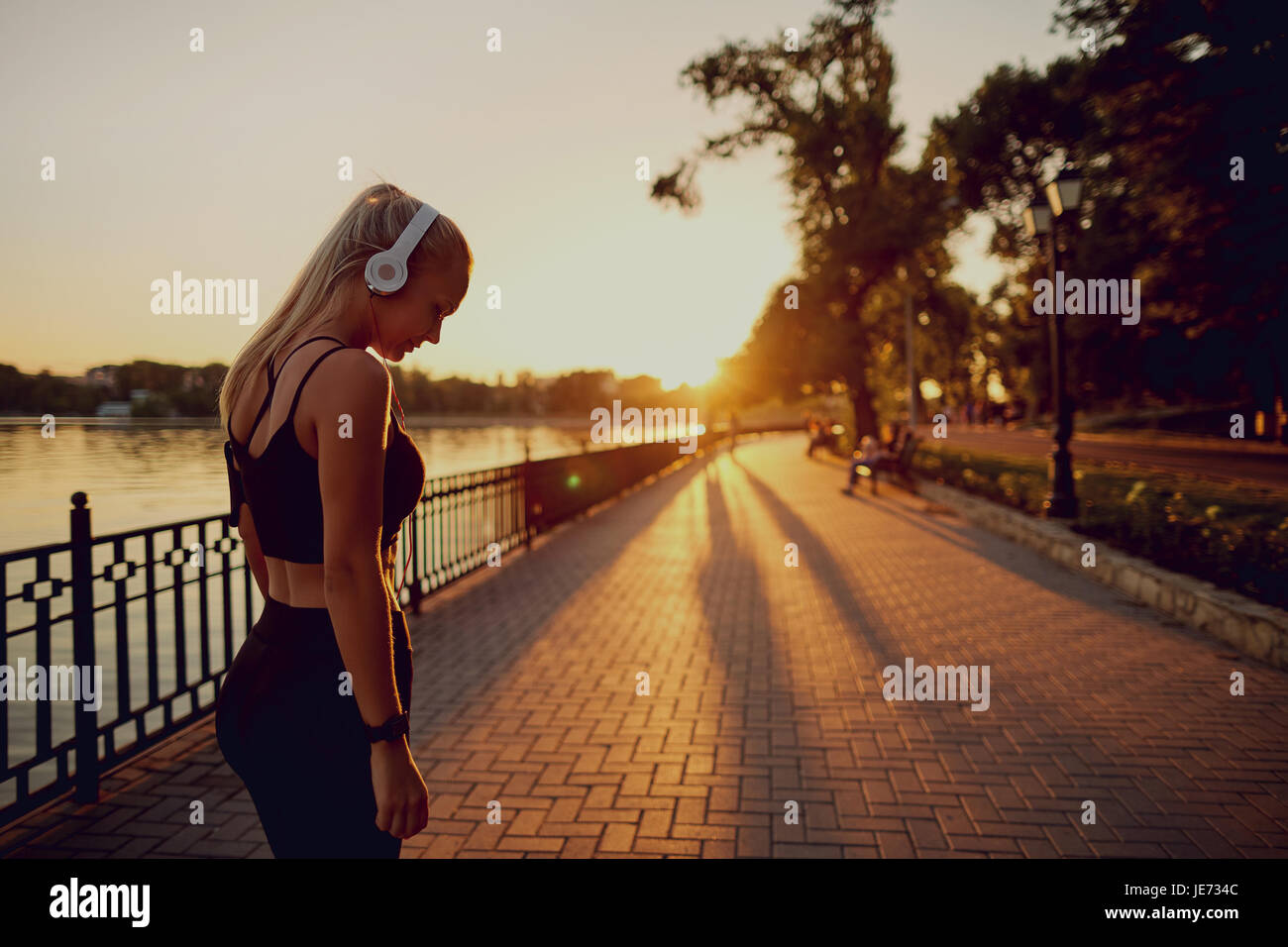 Woman running with headphones hi-res stock photography and images - Alamy
