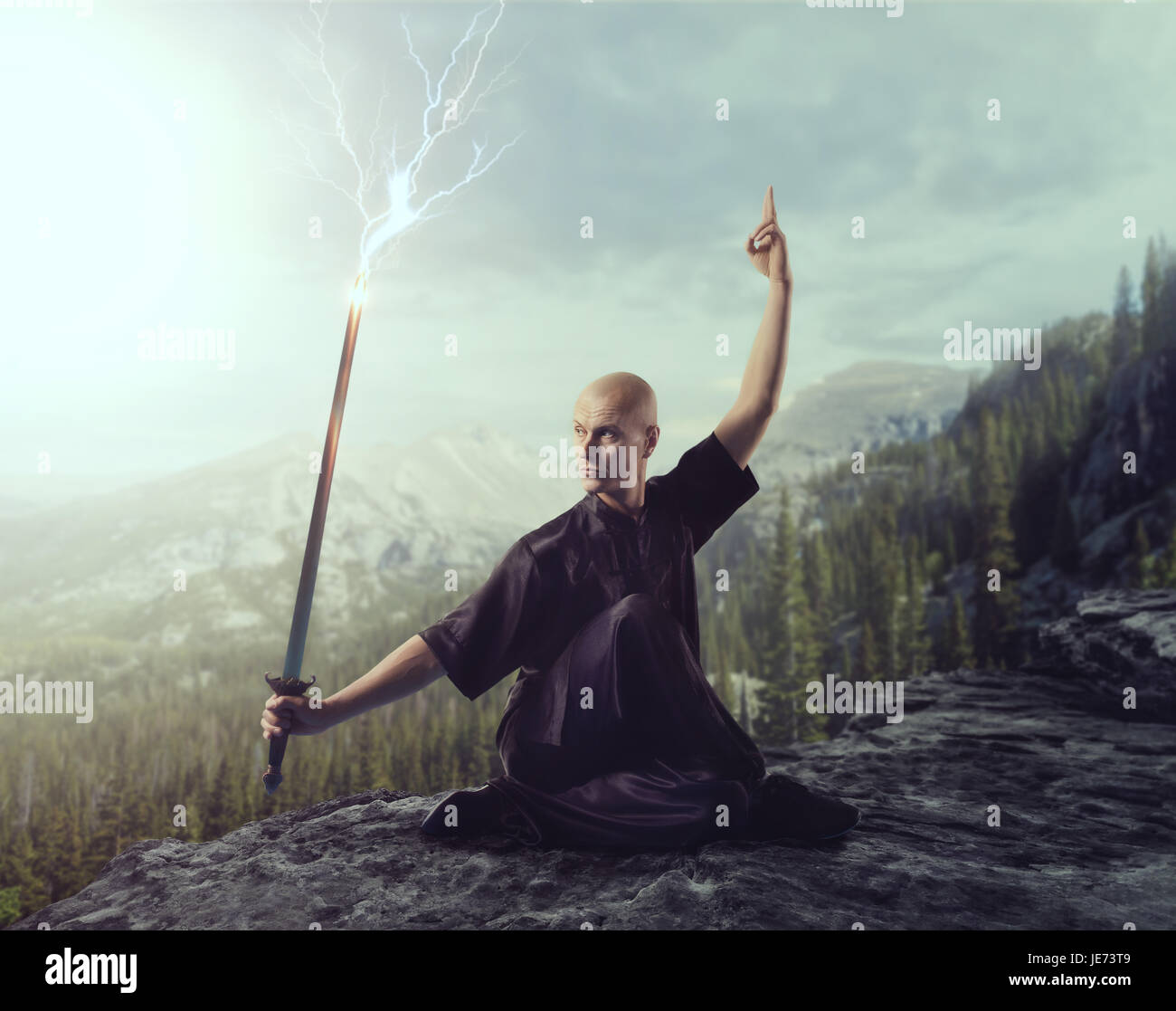 Wushu master with blade, lightning control on the top of mountain ...