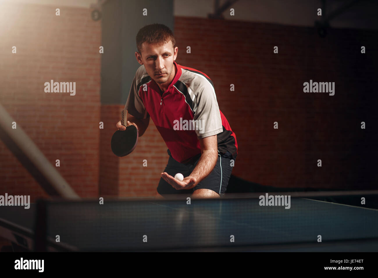 Man with racket in action, playing table tennis. Ping pong training ...