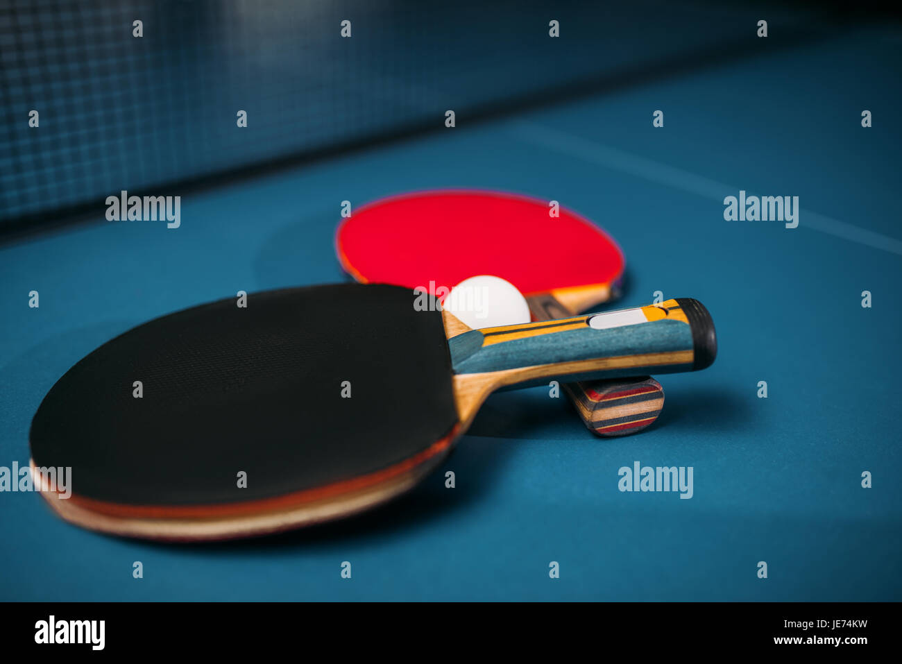 Two tennis rackets and ball on the table closeup, game concept. Ping ...