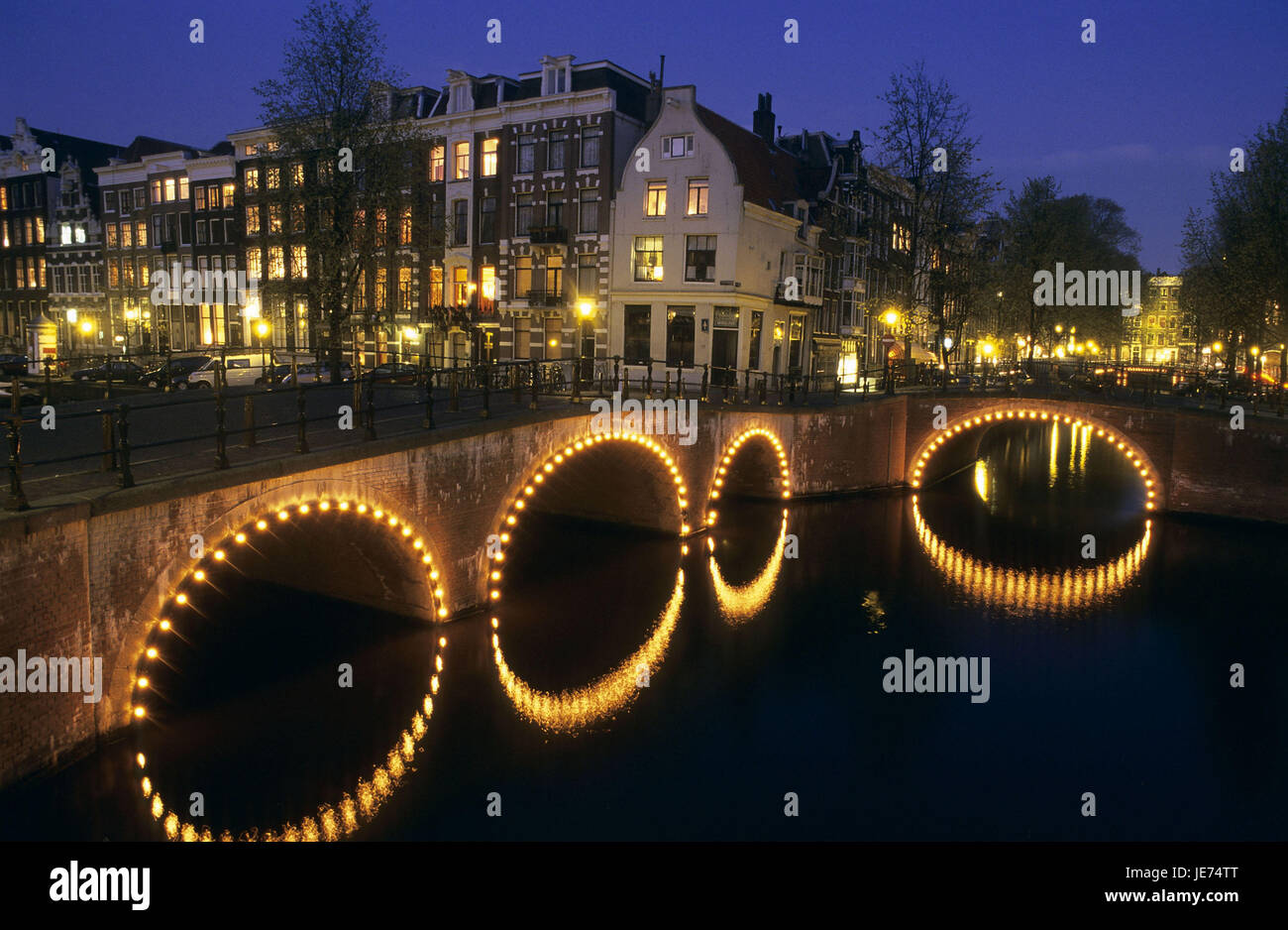 Holland, the Netherlands, Amsterdam, illuminateded bridge at night ...