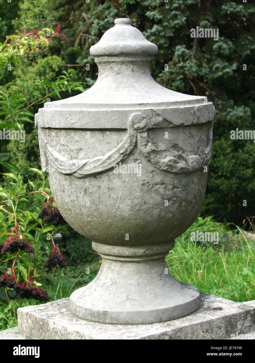 Ivy spilling over and around a granite urn Stock Photo - Alamy