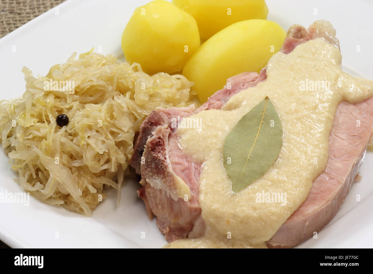 Traditional german pork meat with sauerkraut and potatoes Stock Photo ...
