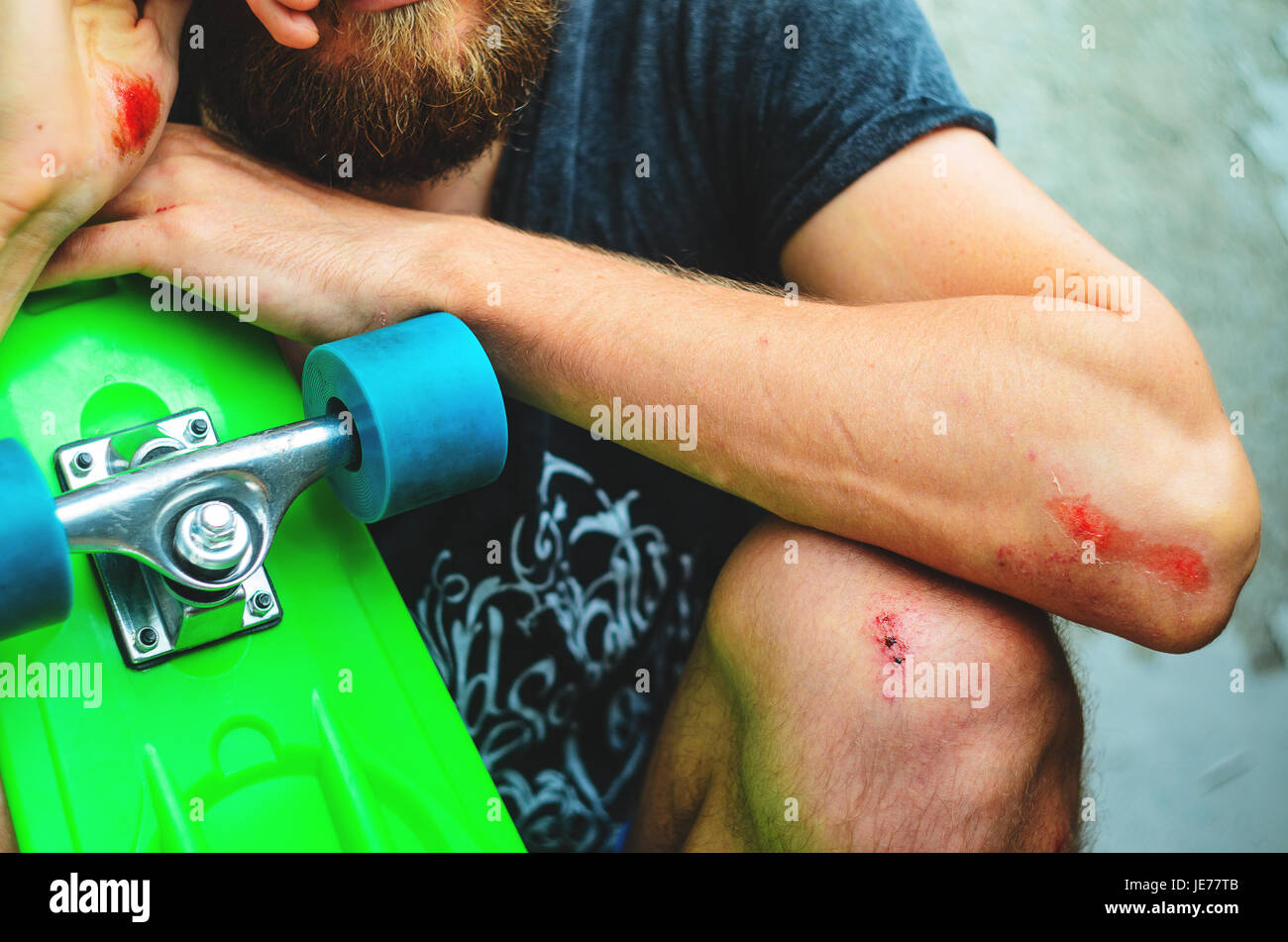 Closeup of a young caucasian man with a skate board in his hand ...