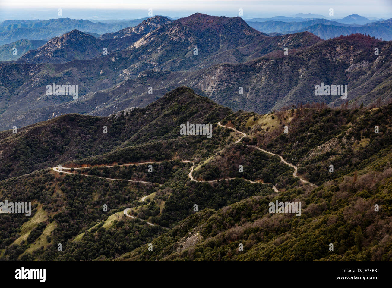 Winding road descends mountains in switchback pattern Stock Photo - Alamy