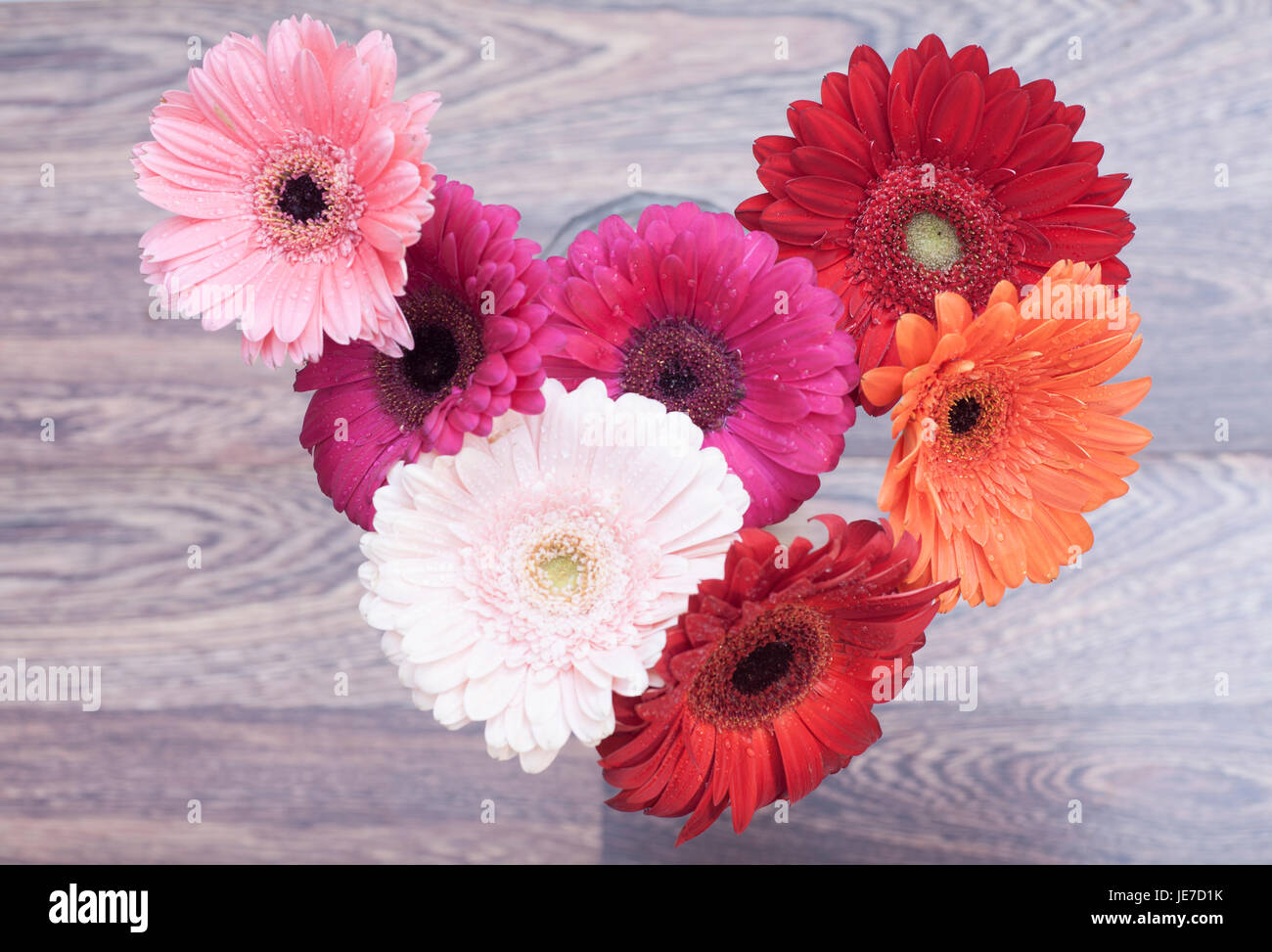 bouquet of gerberas on wooden background Stock Photo - Alamy