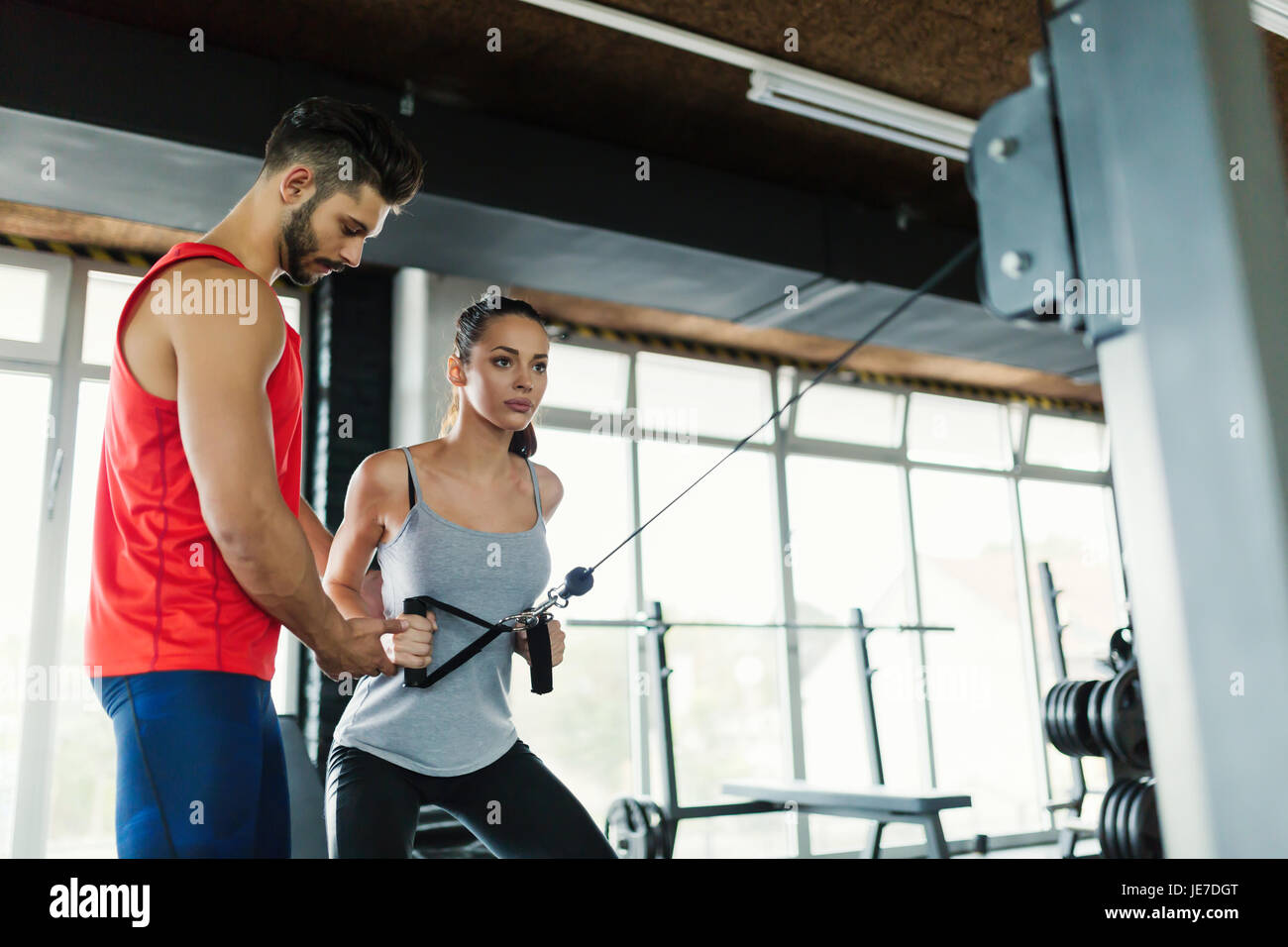 Beautiful woman doing exercises with her trainer Stock Photo - Alamy