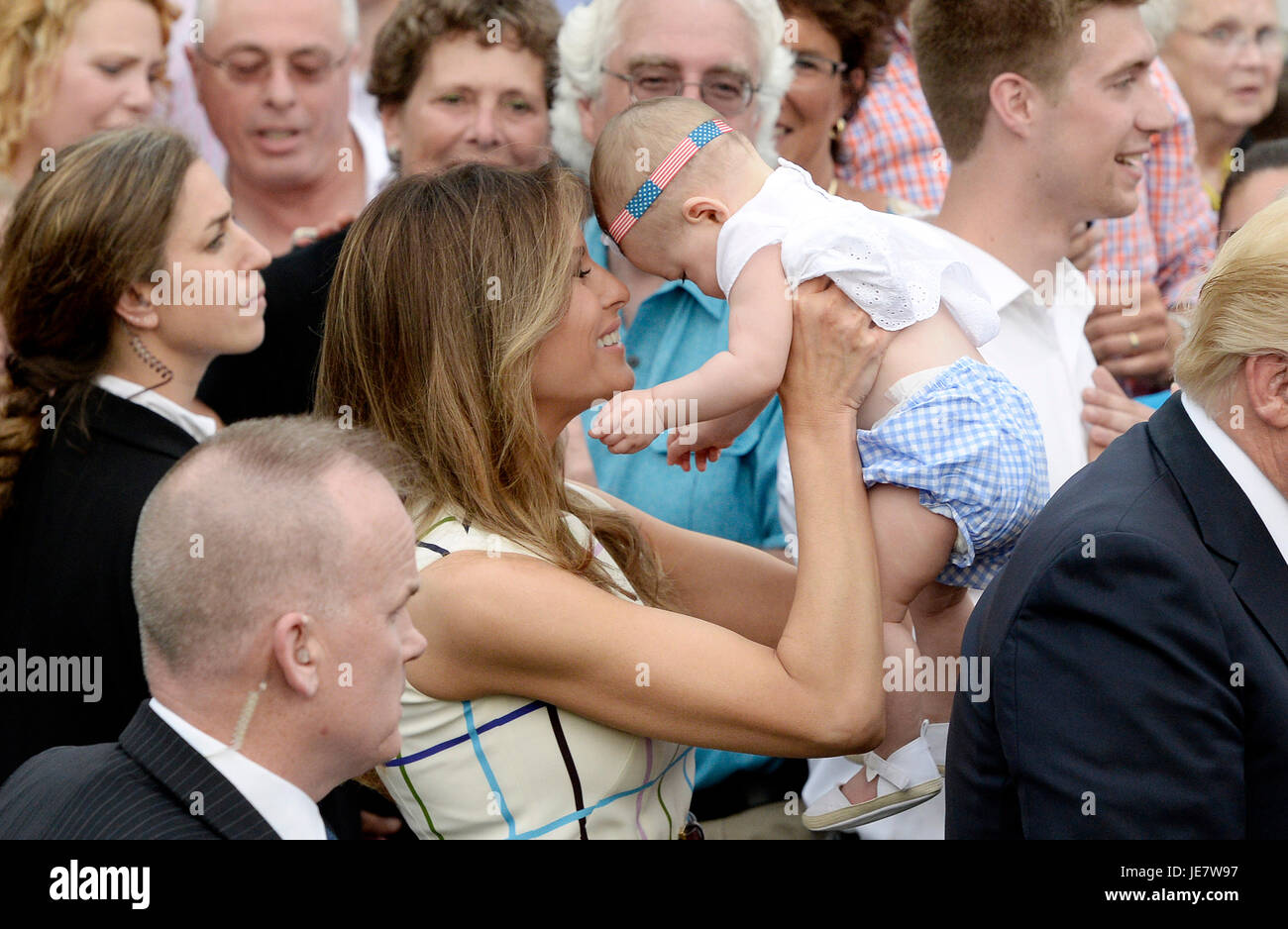 First Lady Melania Trump holds a baby during the Congressional Picnic ...