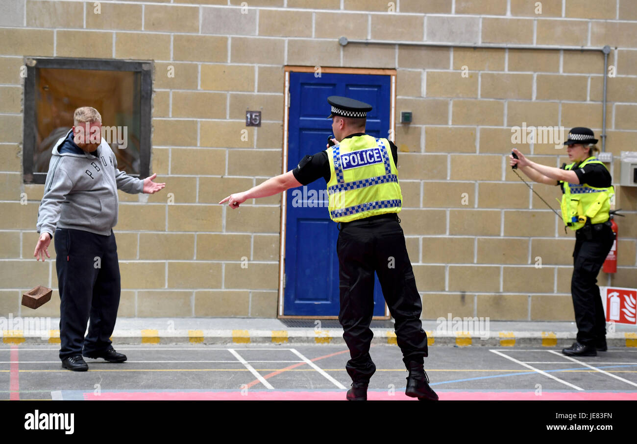 Police officers demonstrate attending a domestic incident during ...