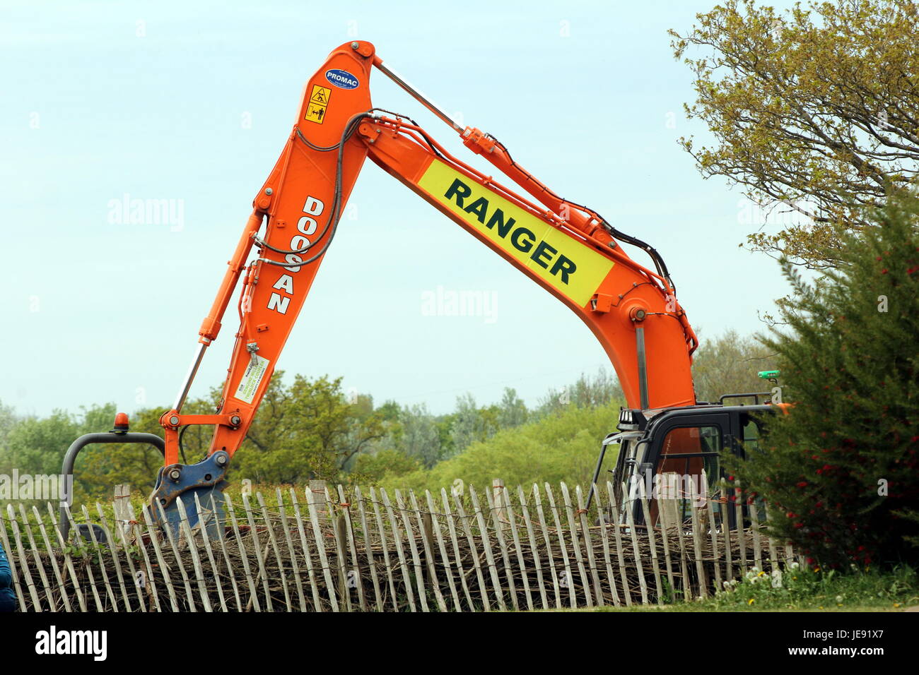 Orange commercial Doosan digger or earthmover, often known as a JCB ...