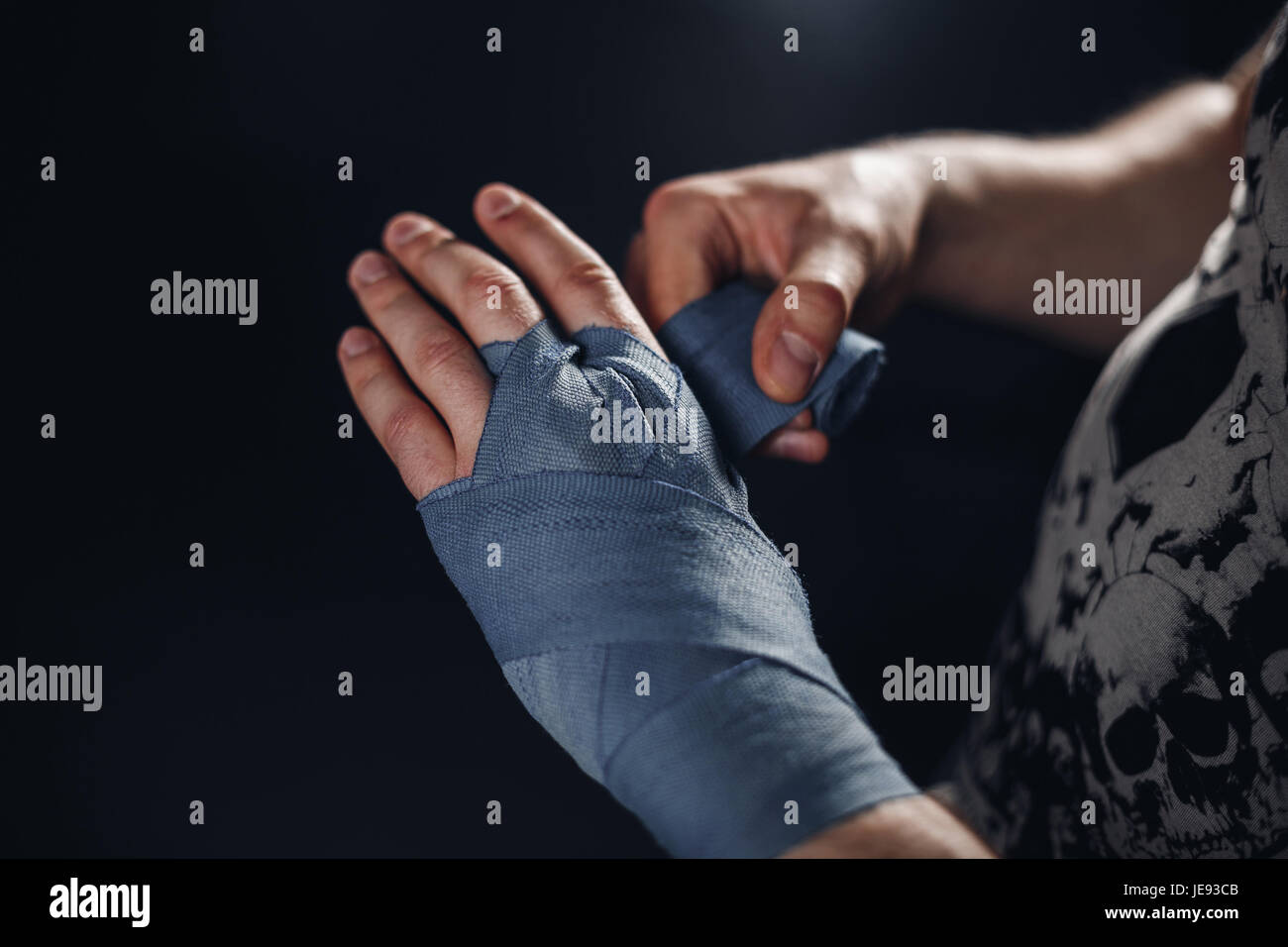Man is wrapping hands with blue boxing wraps Stock Photo - Alamy