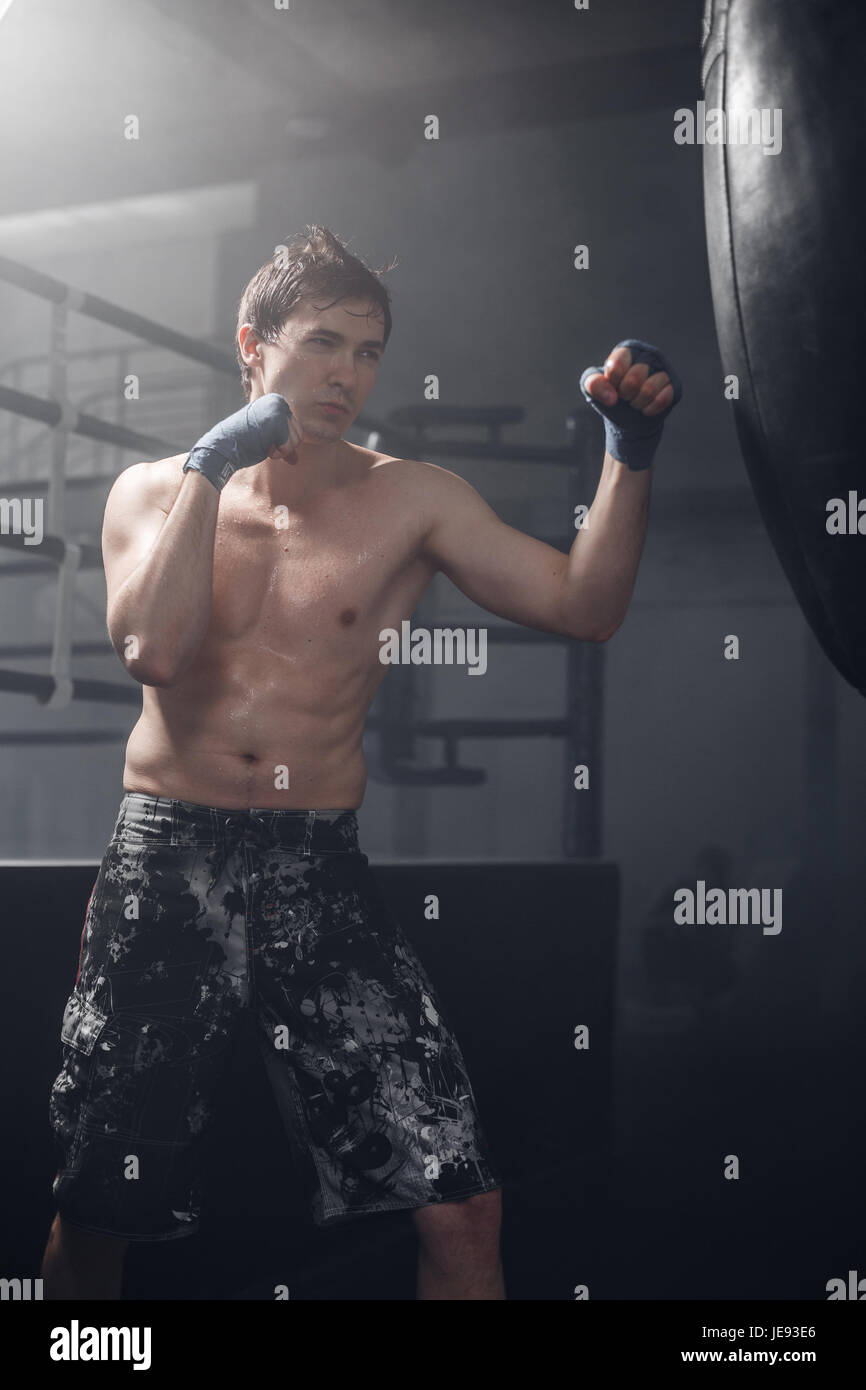 Young man doing boxing workout in the gym Stock Photo - Alamy