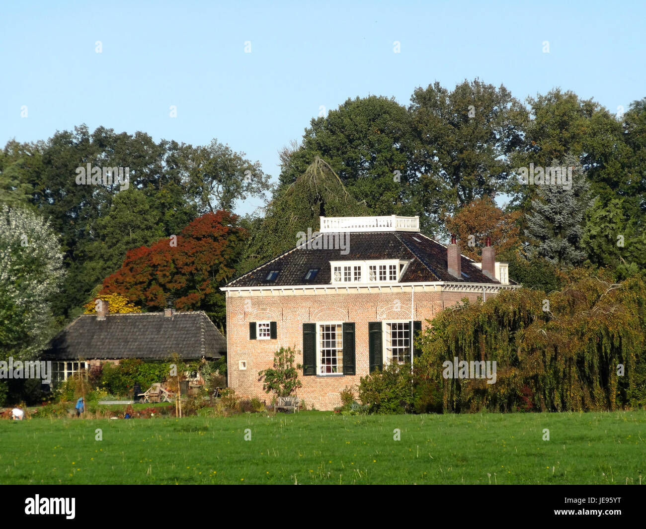This photograph features the historic building Huize Den Doorn, located ...