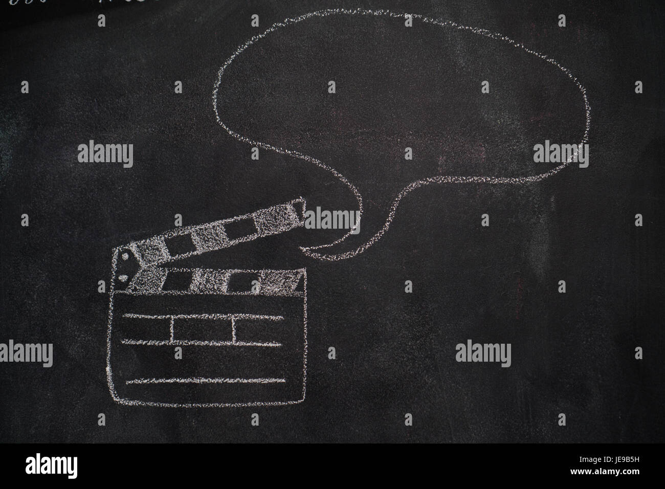 Open movie clapper with empty speech bubble drawn with chalk on ...