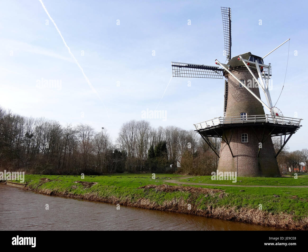 The image depicts 'De Juffer' windmill located along the Hunze River ...