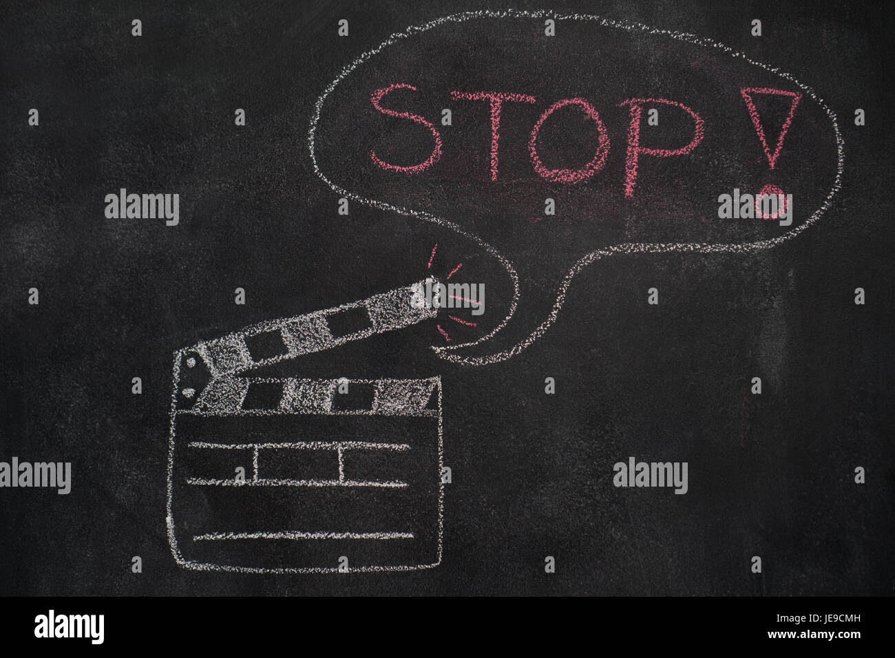 Open movie clapper and speech bubble with stop word drawn with chalk on ...