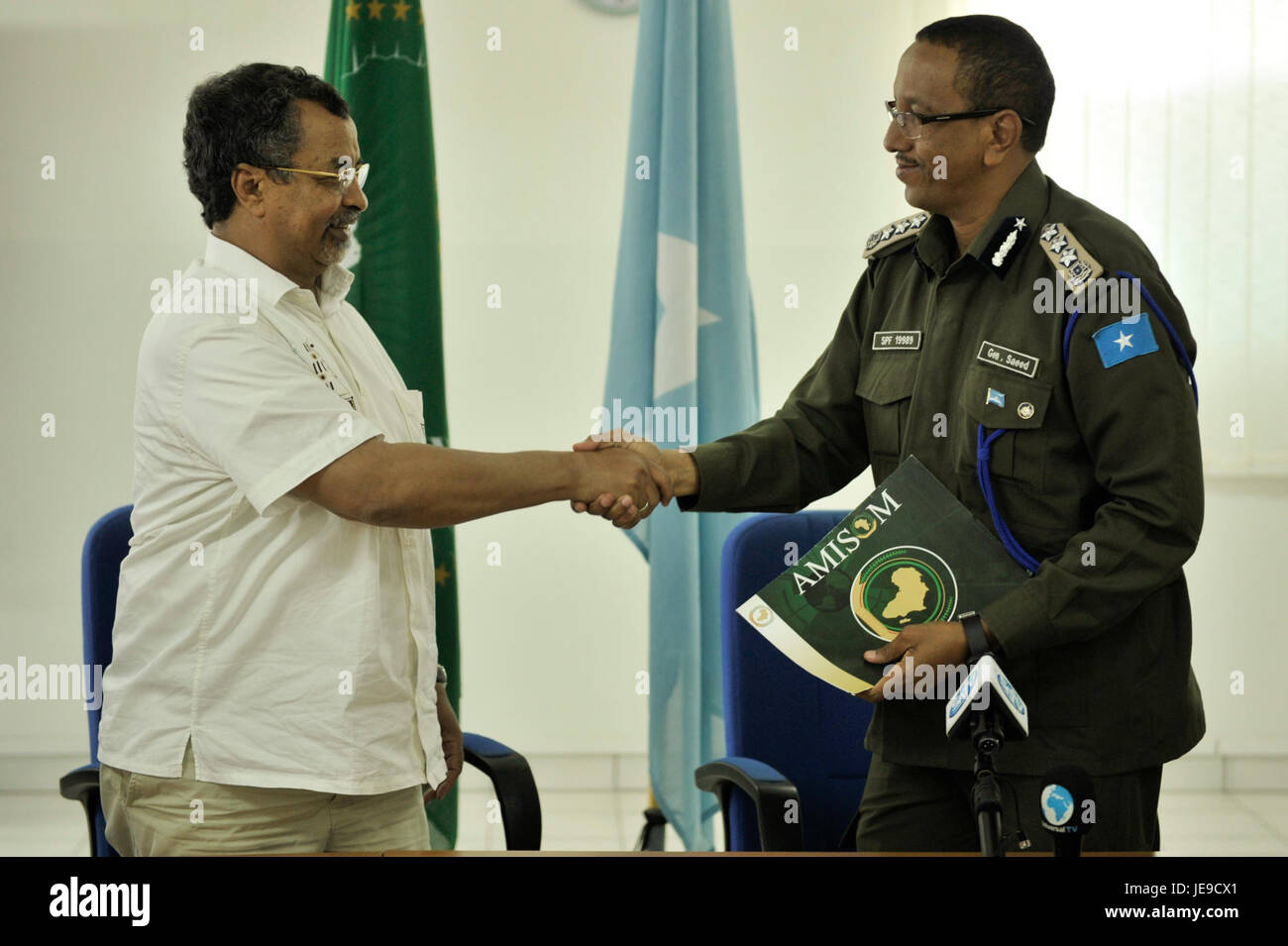 This image shows a vehicle handover ceremony in 2014, where military ...