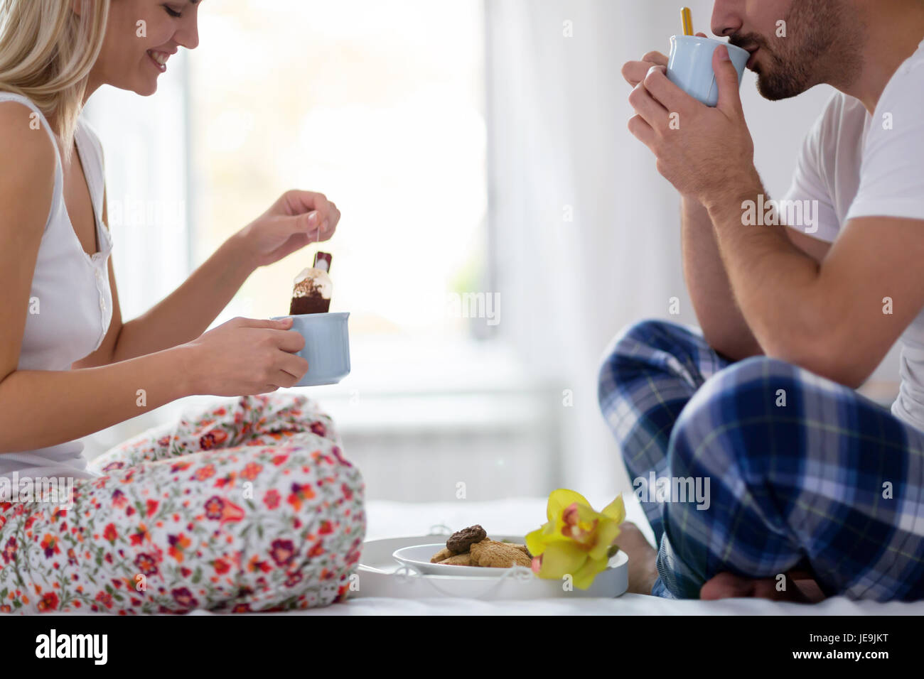 Romantic happy couple having breakfast in bed Stock Photo - Alamy