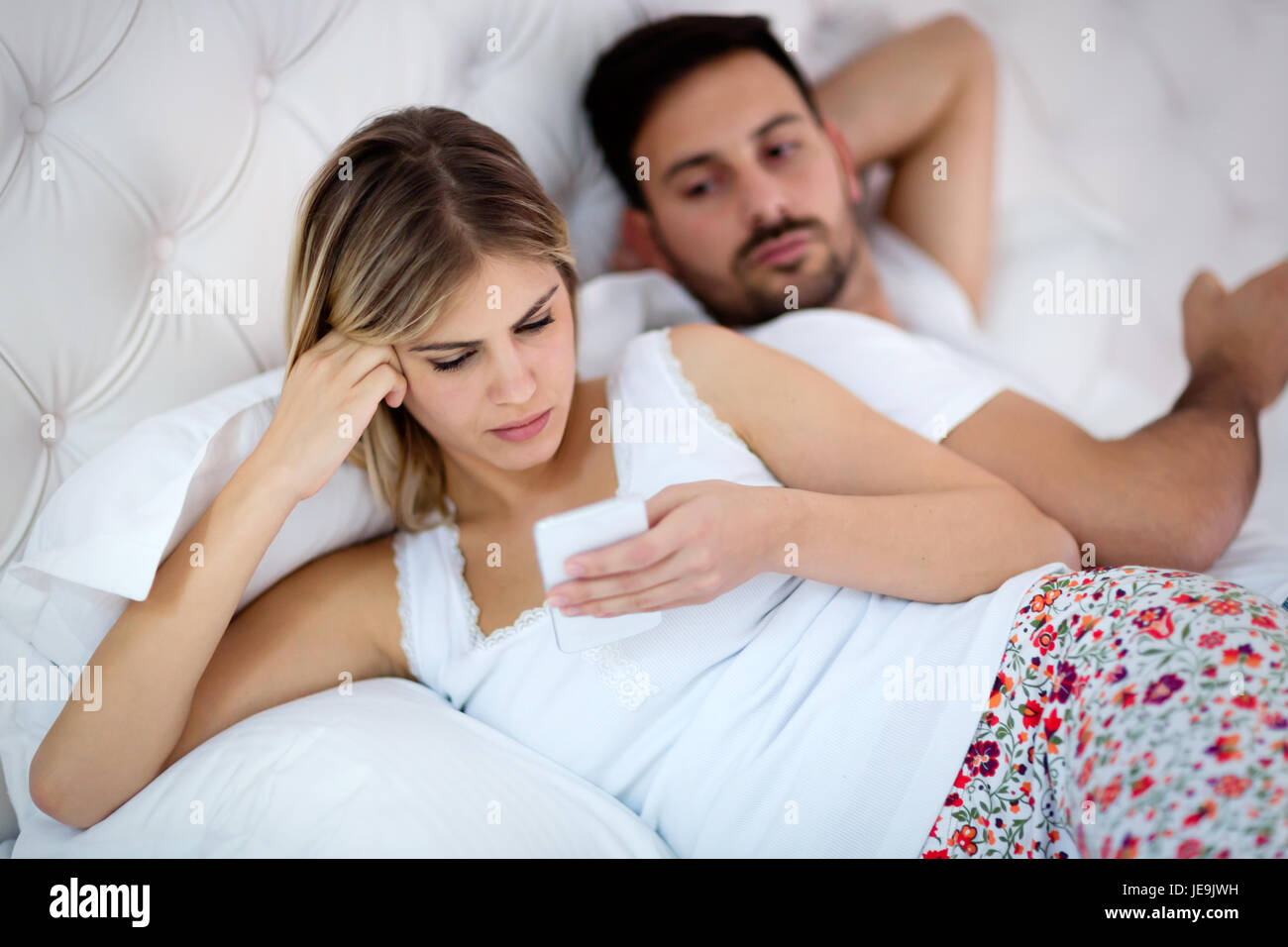 Young couple in bed having problems and crisis Stock Photo - Alamy