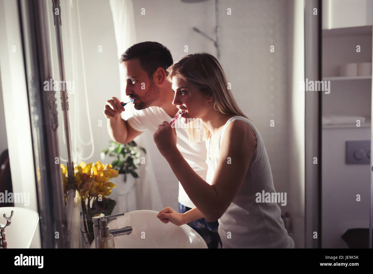 Attractive couple washing teeth in morning together Stock Photo - Alamy