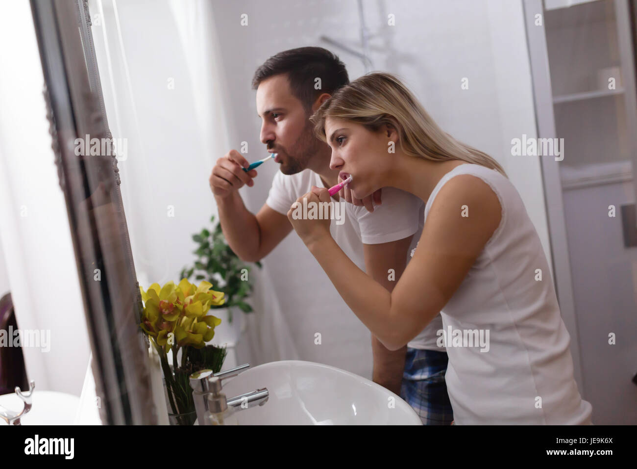 Attractive couple washing teeth in morning together Stock Photo - Alamy