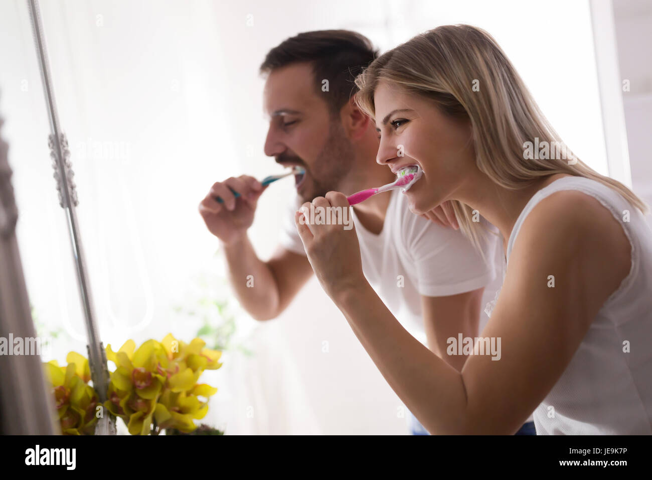 Attractive couple washing teeth in morning together Stock Photo - Alamy