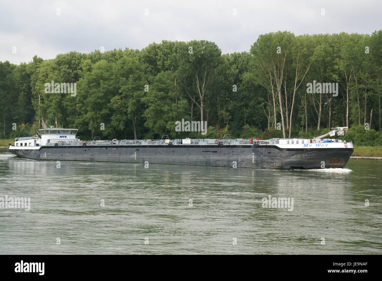 This photograph shows a ship navigating the Rhine River near Rheinsheim ...