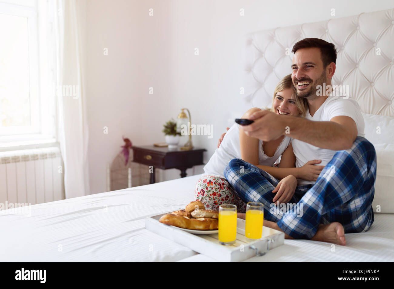 Romantic happy couple having breakfast in bed Stock Photo - Alamy