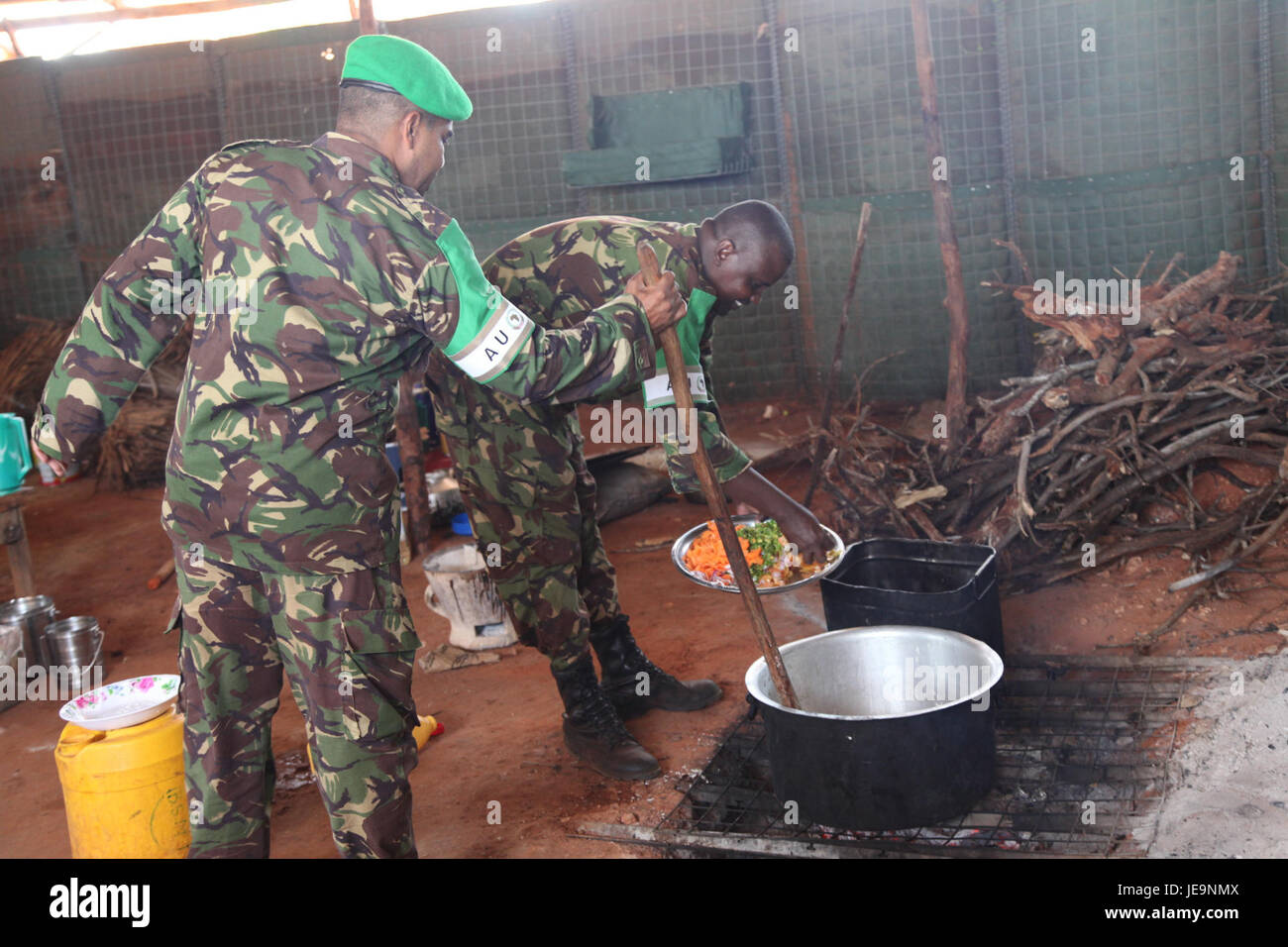 This photograph captures KDF soldiers preparing for Iftar, a meal at ...