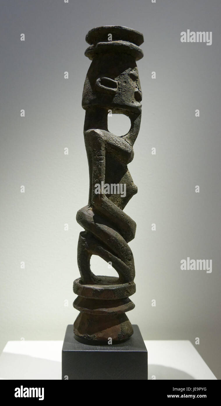 A Dogon kneeling female figure on display at an exhibition, showcasing ...