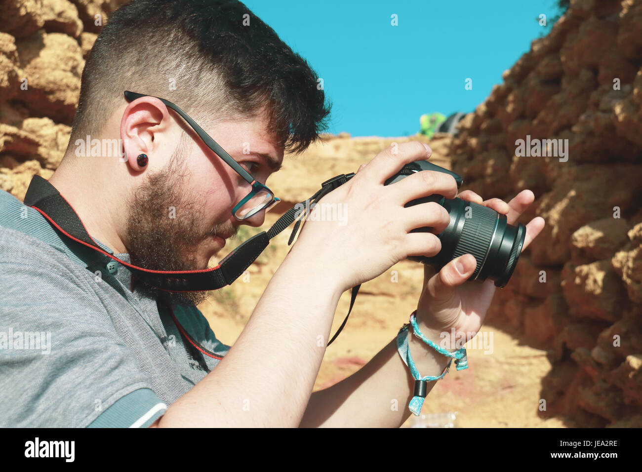 Young photographer looking at the screen of his camera Stock Photo - Alamy